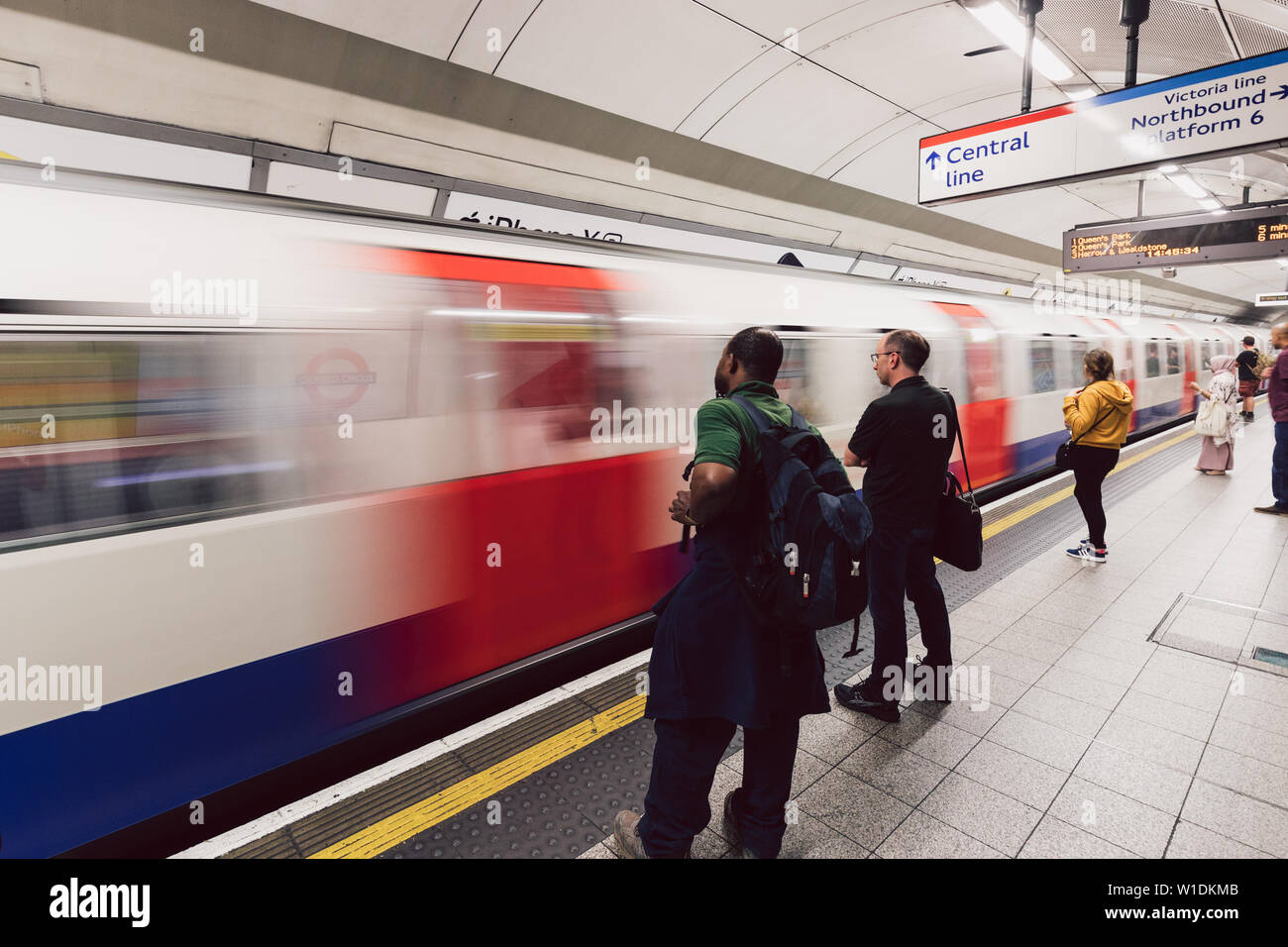 LONDON - JUNE 26, 2019: People and train on platform at tube train ...