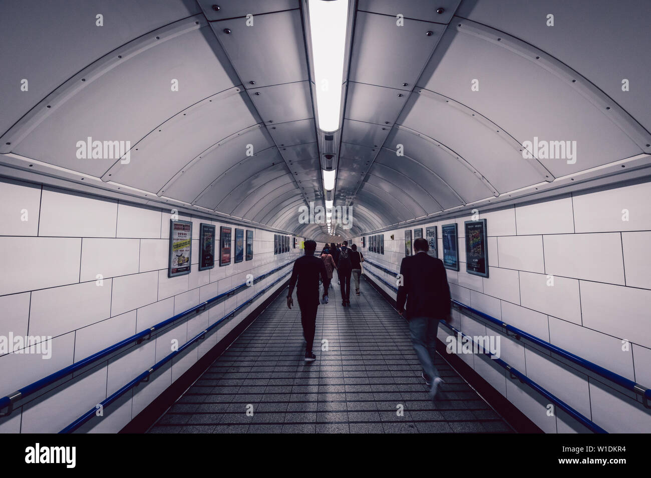 LONDON - JUNE 26, 2019: People walking in modern city tunnel on London ...