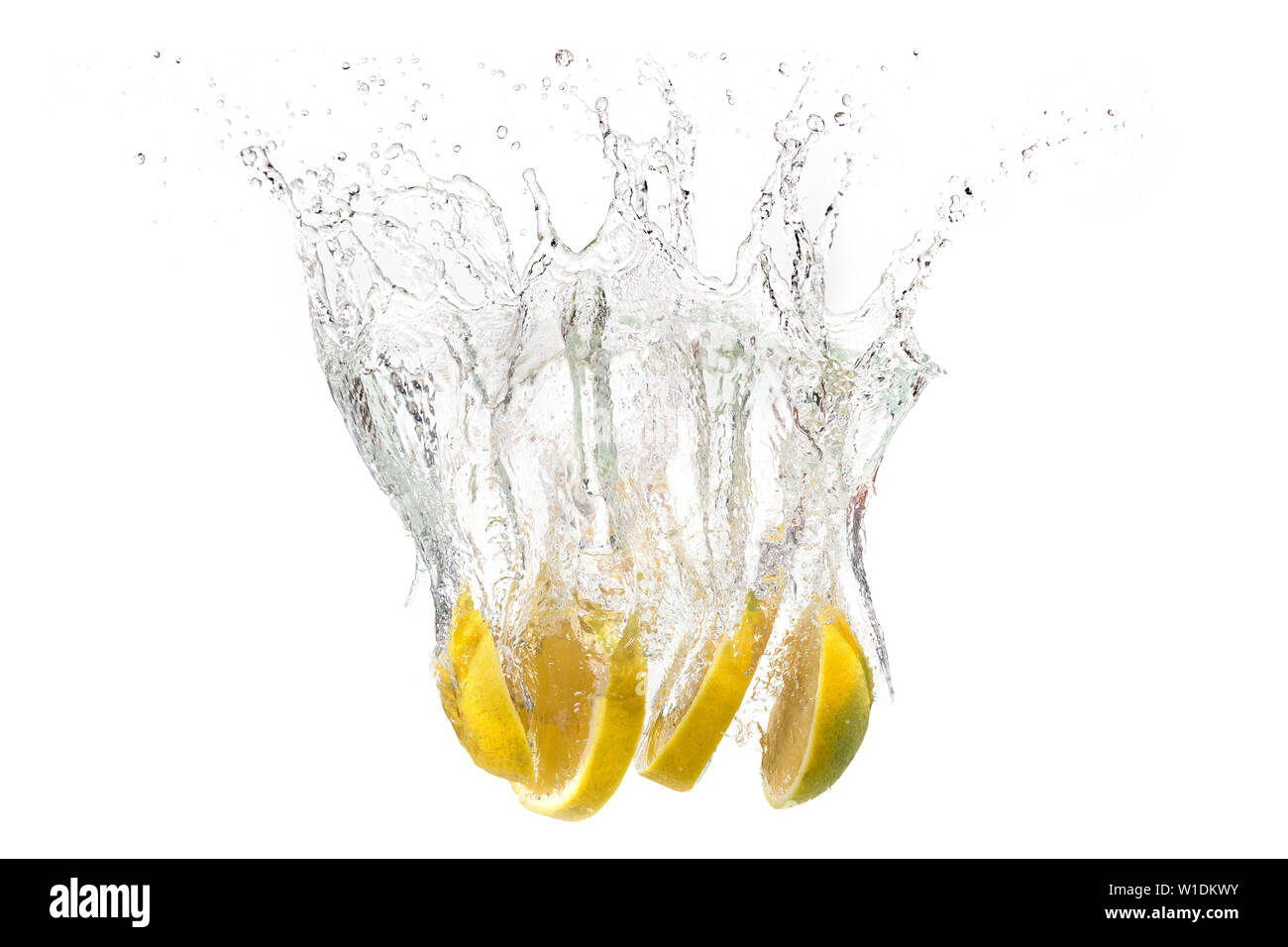Fresh lemon dropped into water with splash isolated on white Stock Photo - Alamy