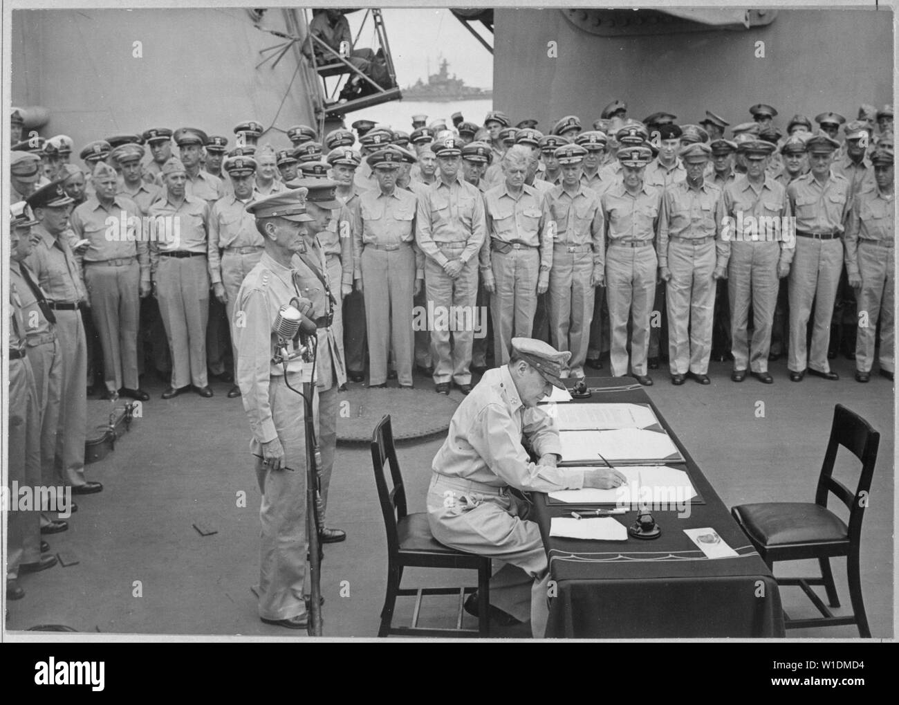 General Douglas MacArthur signs as Supreme Allied Commander during ...