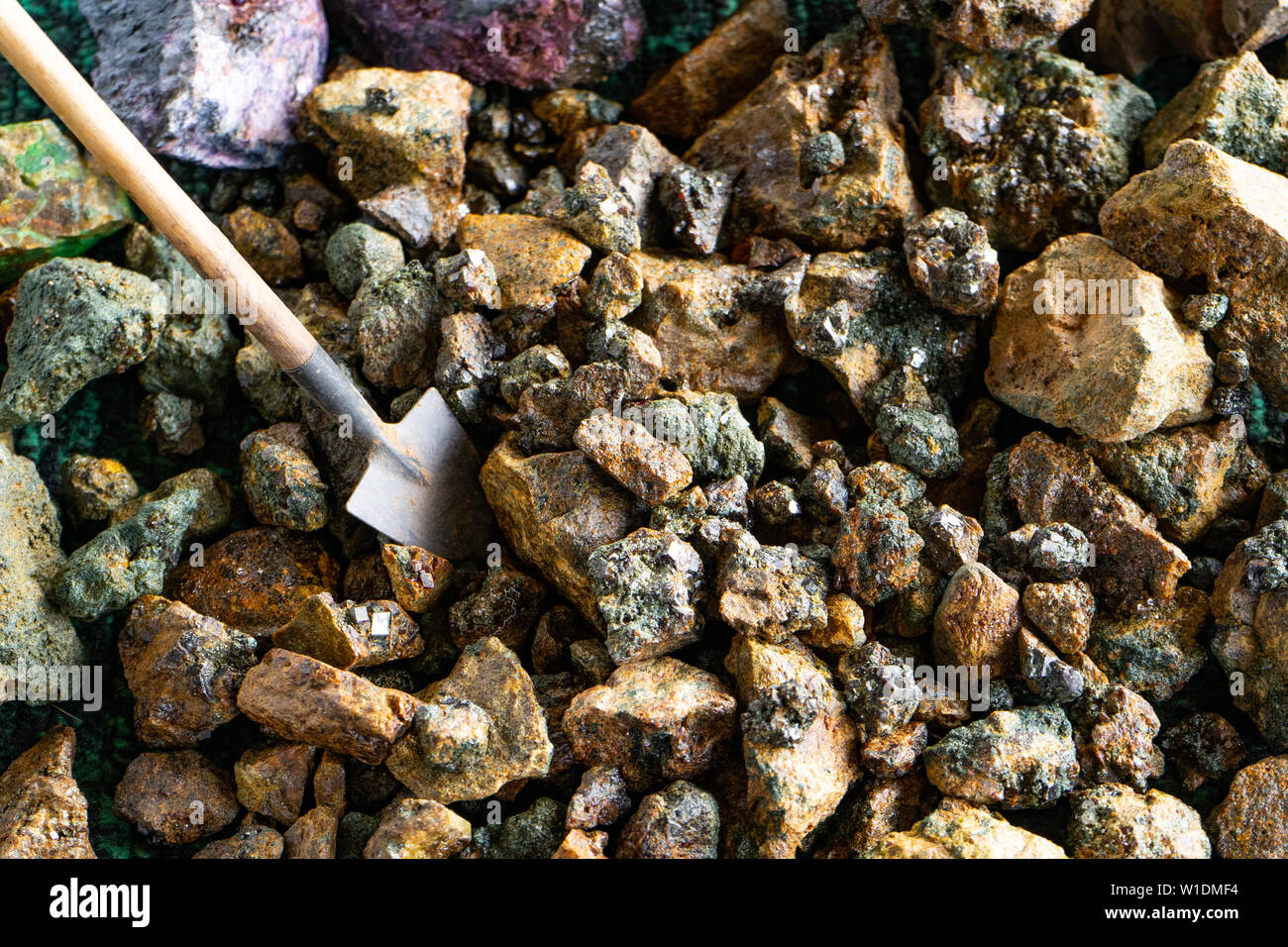 Mining. A miniature shovel and pieces of minerals with crystals Stock ...