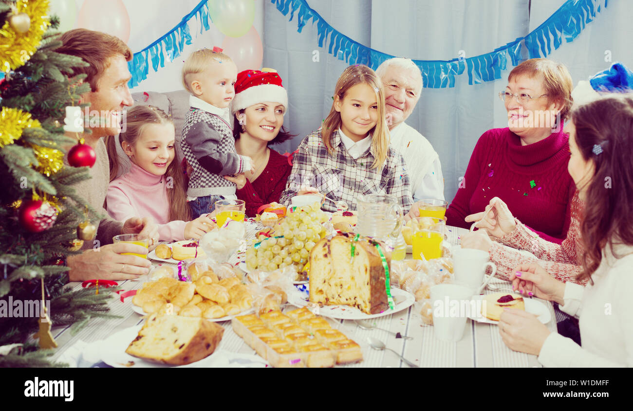 Family with children are engaging in dialog during celebration ...
