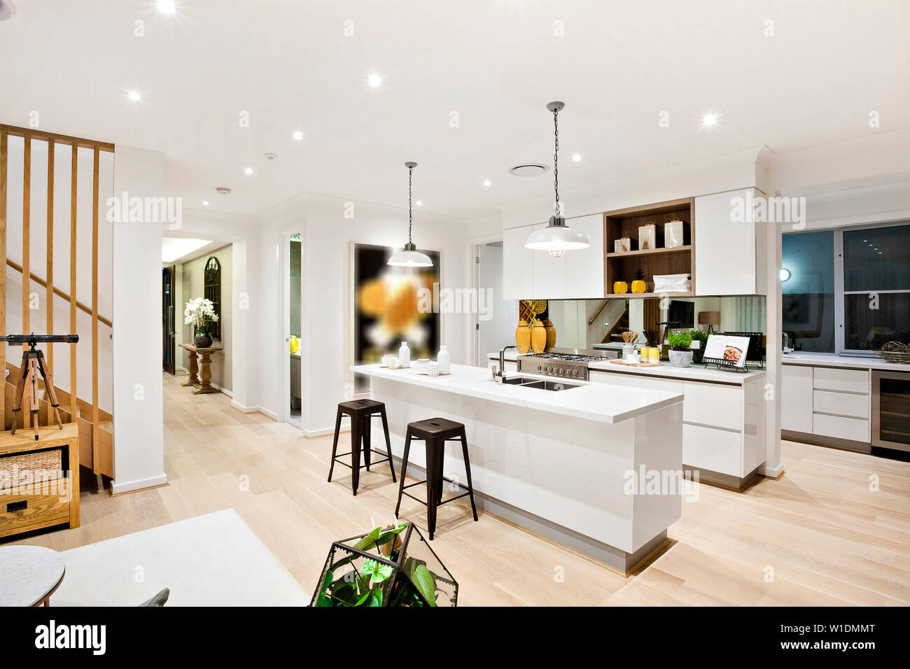A stylish wooden staircase in front of a stylish modular kitchen with ...