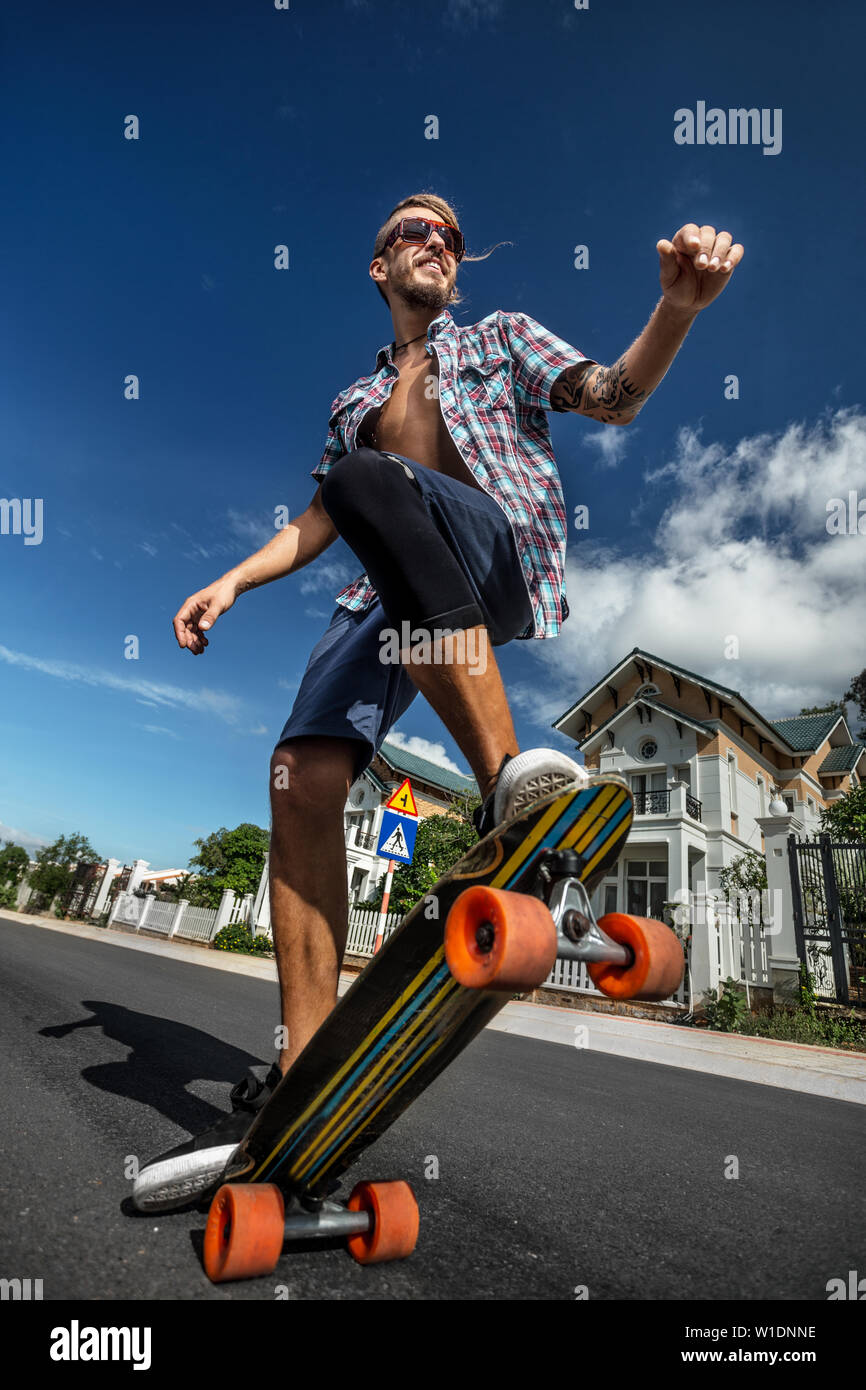 Skating man riding on a skateboard Stock Photo - Alamy
