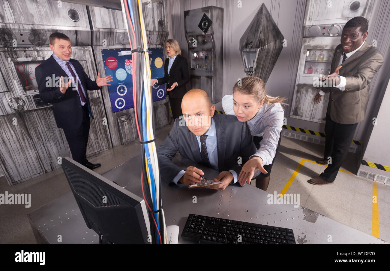 Men and women in business suits solving quests to get out of escape ...