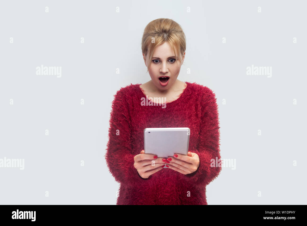 No way! Portrait of beautiful unbelievable young woman in red blouse ...