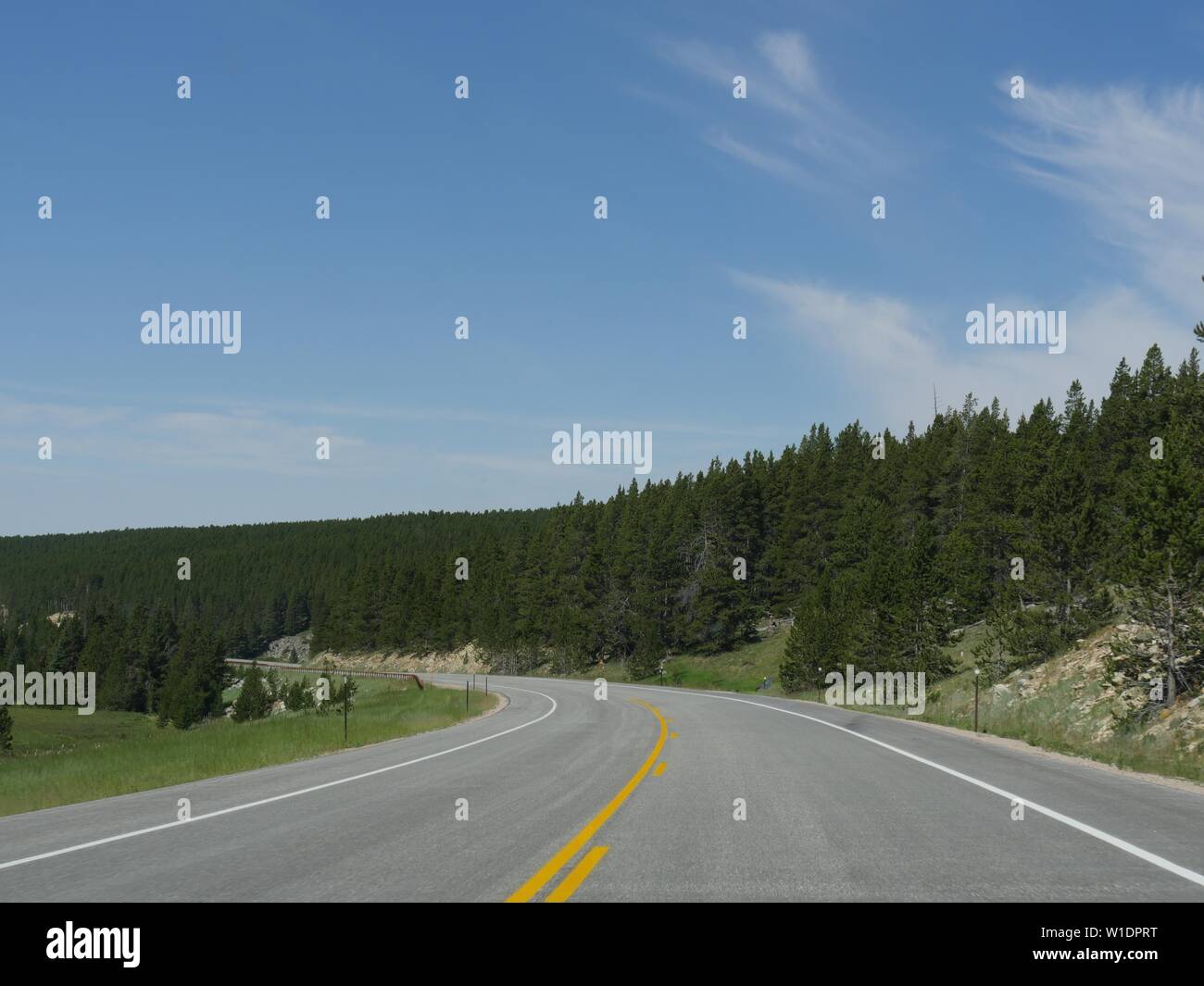 Medium close up of a curve in a smooth highway at Washakie County at ...
