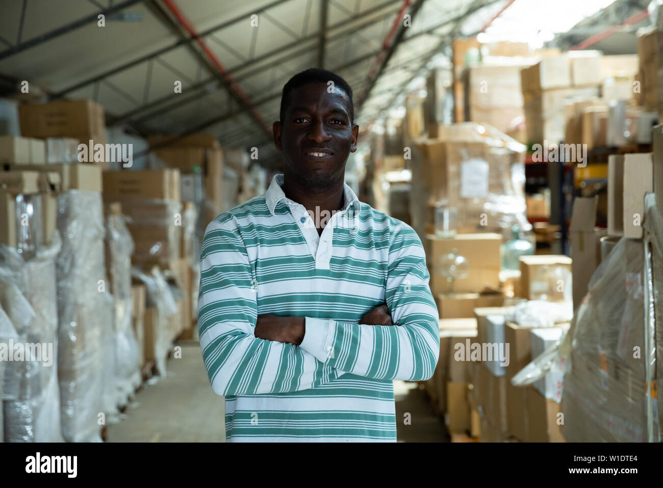 Portrait of confident African American distribution warehouse owner ...
