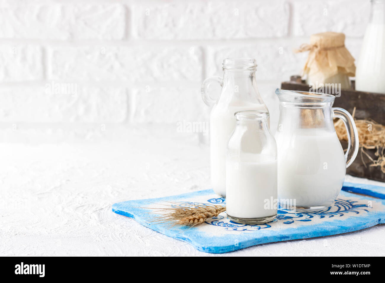 Bottles of milk of various shapes and sizes on a light background Stock ...