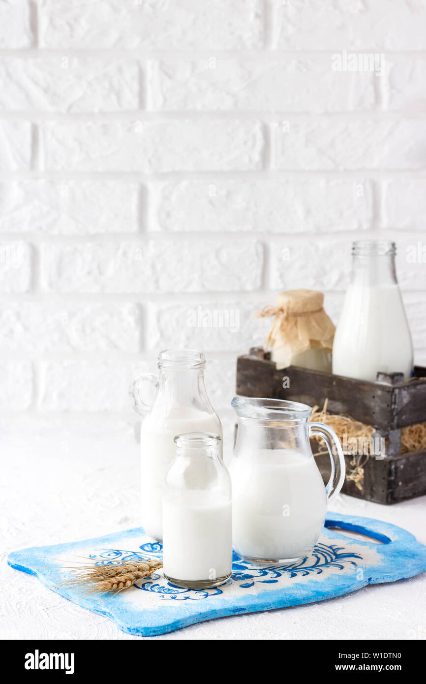 Bottles of milk of various shapes and sizes on a light background Stock ...