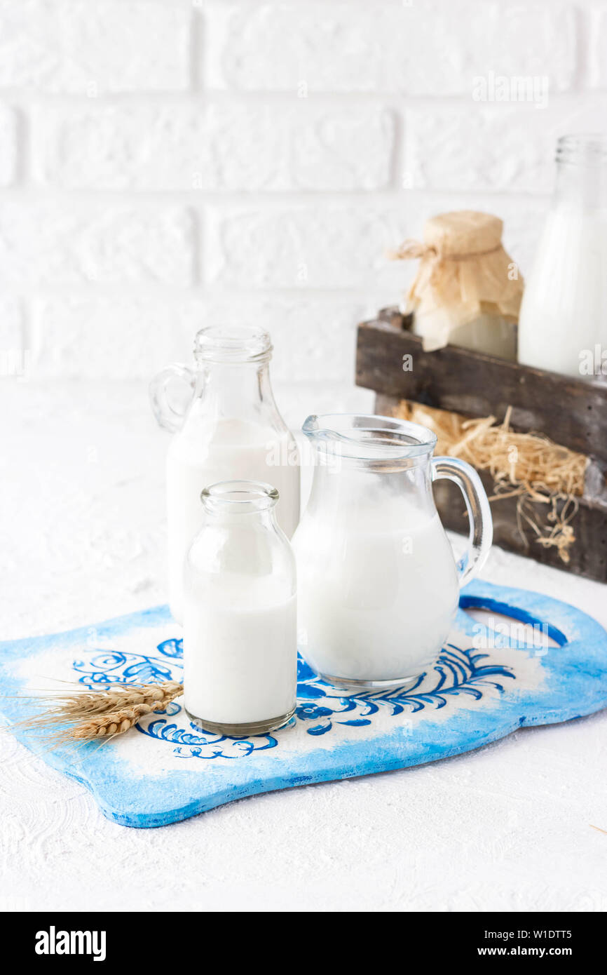 Bottles of milk of various shapes and sizes on a light background Stock ...