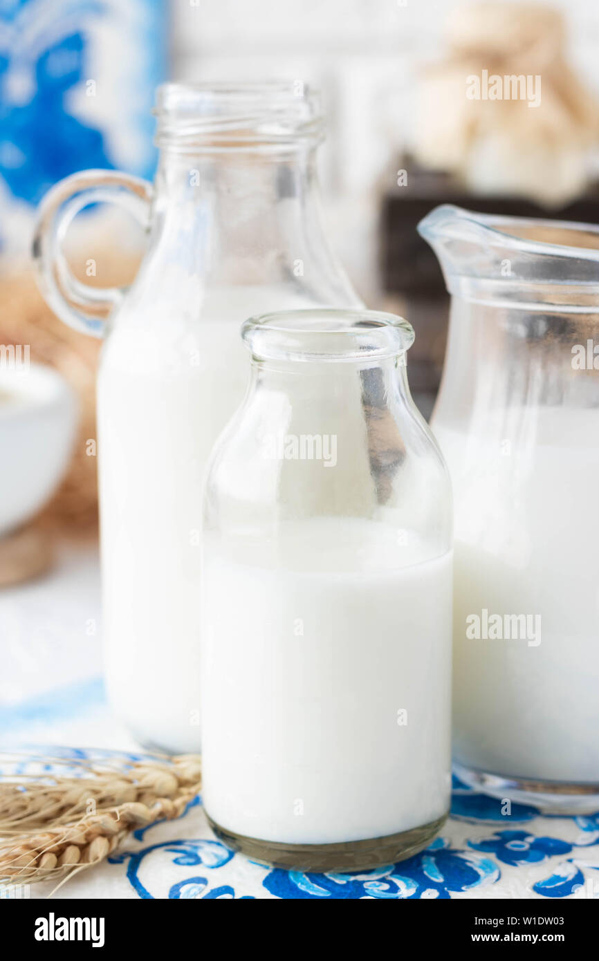Bottles of milk of various shapes and sizes on a light background Stock ...