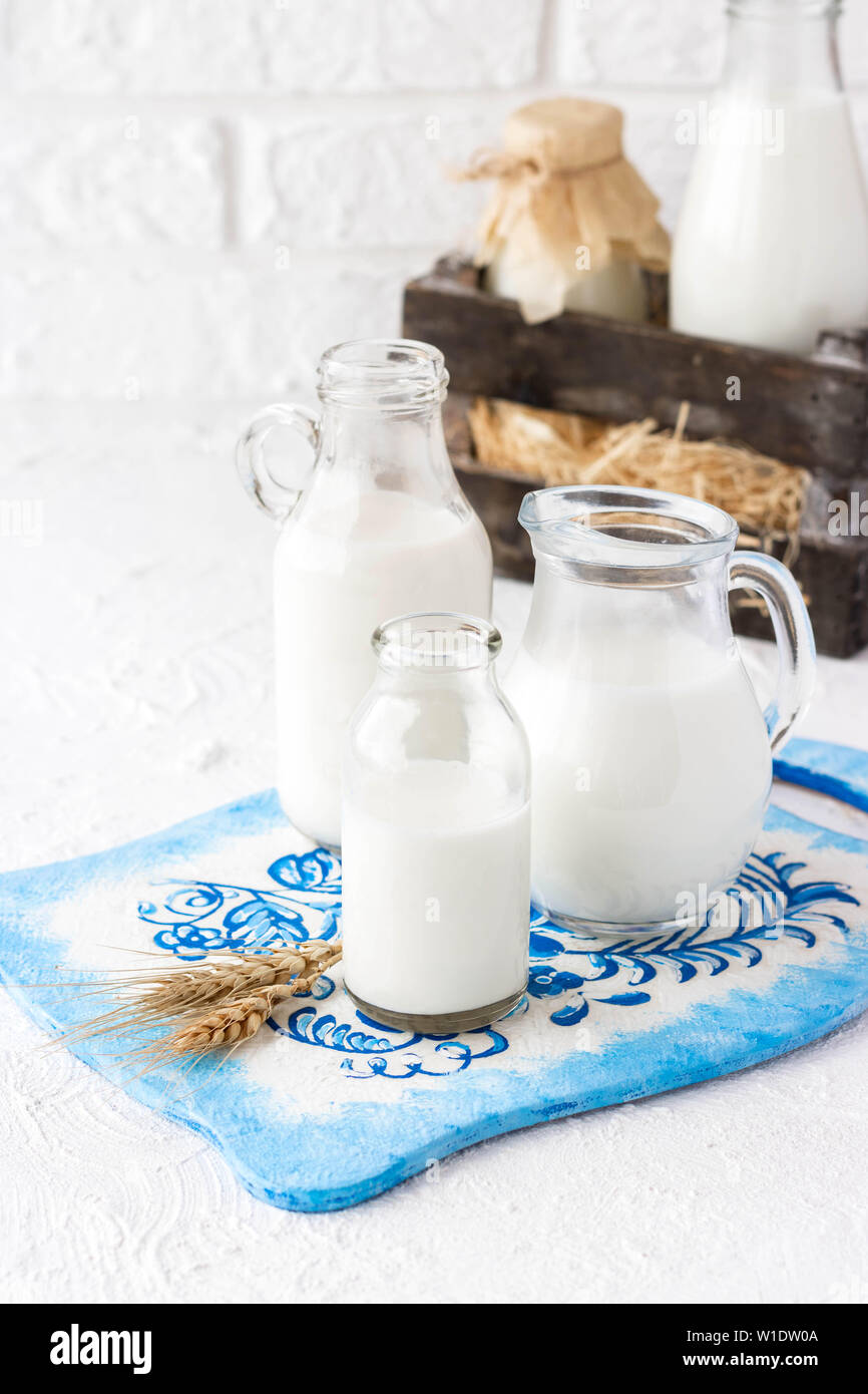 Bottles of milk of various shapes and sizes on a light background Stock ...