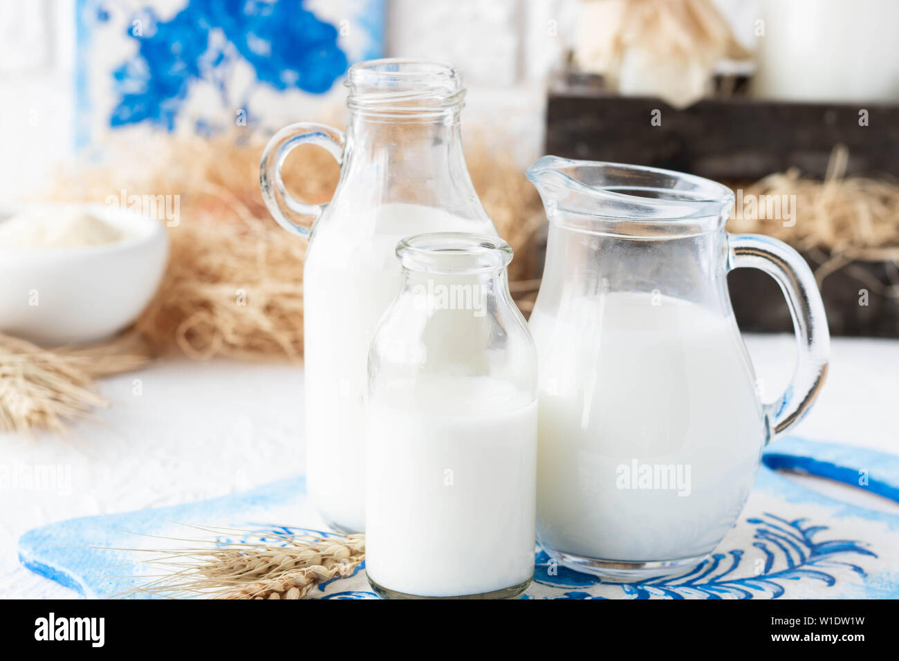 Bottles of milk of various shapes and sizes on a light background Stock ...