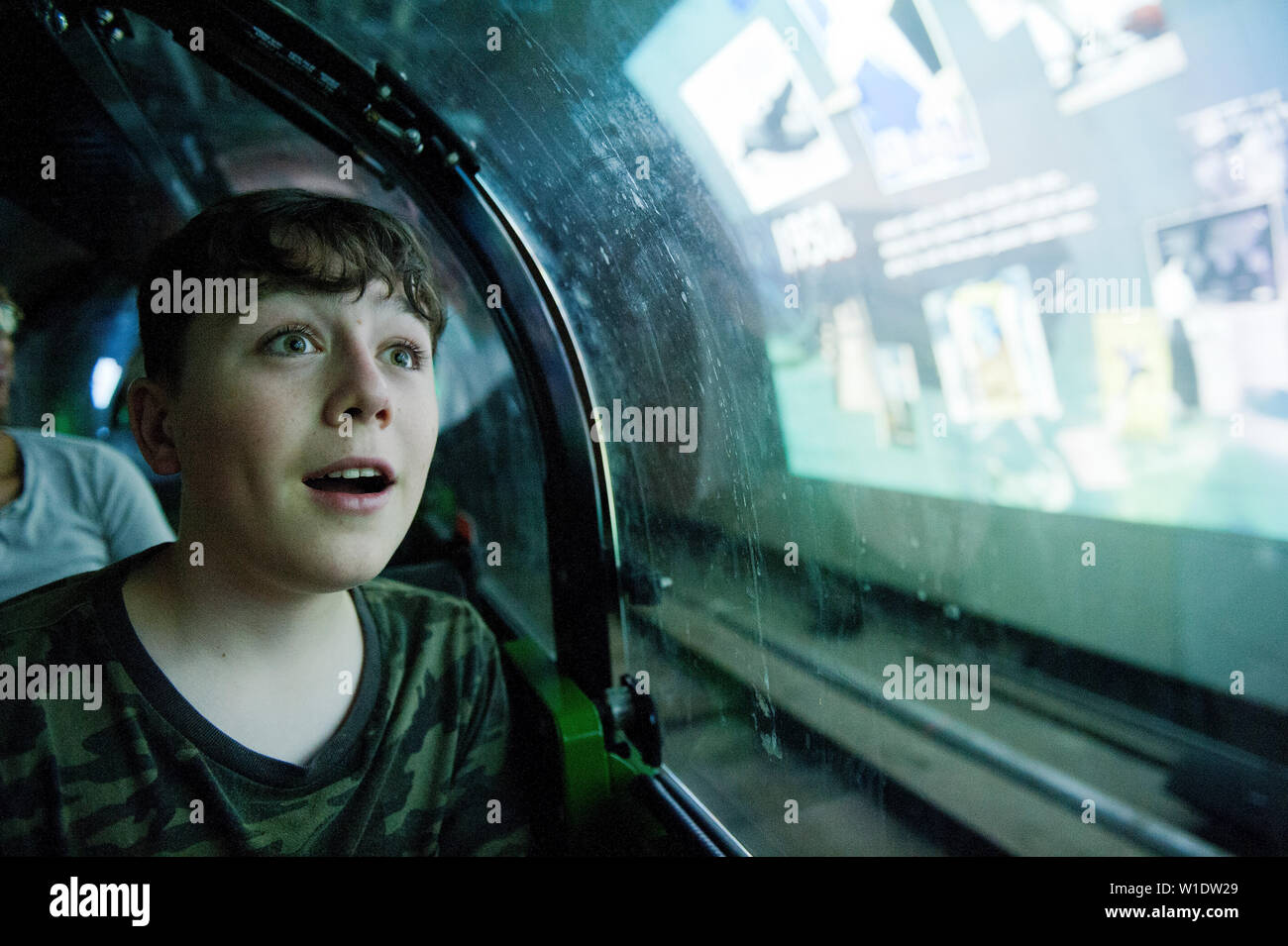 Teenager riding on the Mail Rail train at the postal museum, London ...