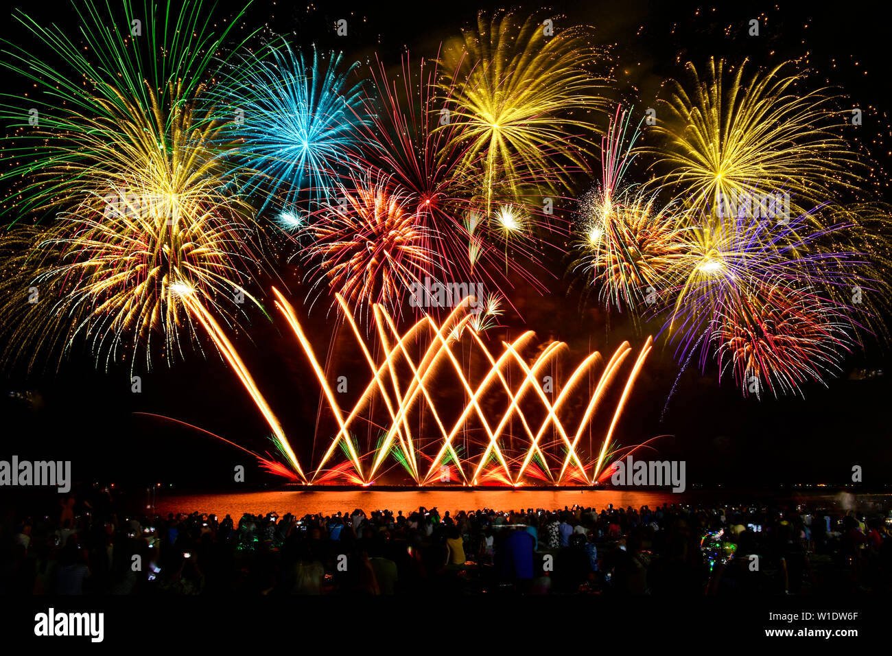 People capturing a fireworks shows with their mobile phone. Colorful ...