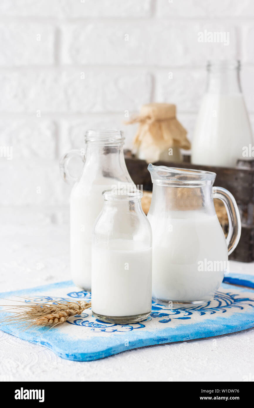 Bottles of milk of various shapes and sizes on a light background Stock ...
