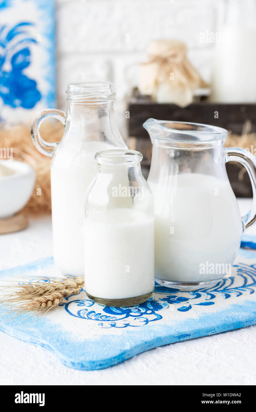 Bottles of milk of various shapes and sizes on a light background Stock ...