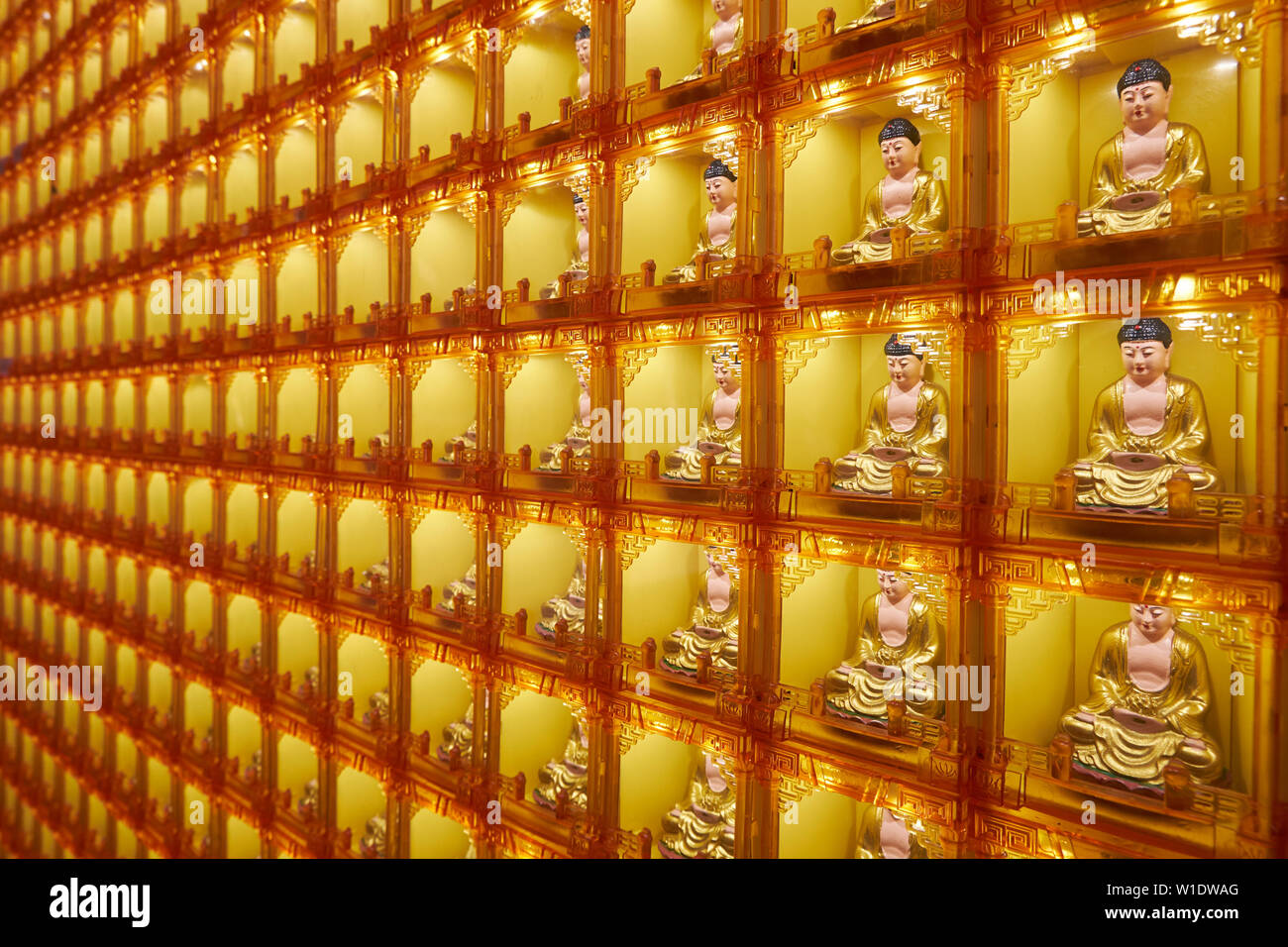 A wall of golden Buddhas in their own boxes inside the Memorial Shrine ...
