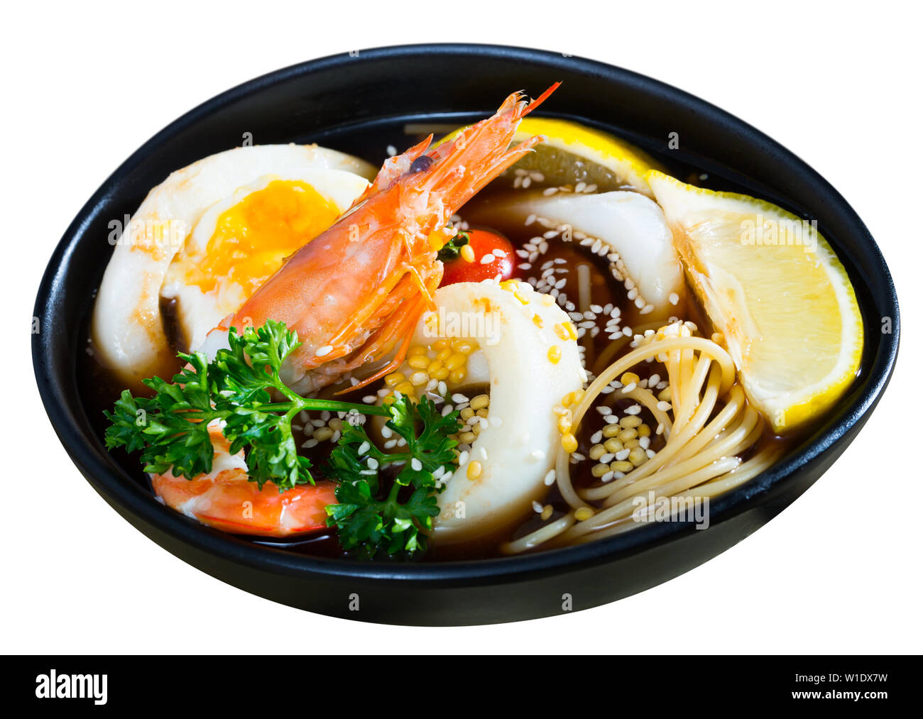 Photography of plate with spicy pan-Asian soup with squid, shrimp, egg ...