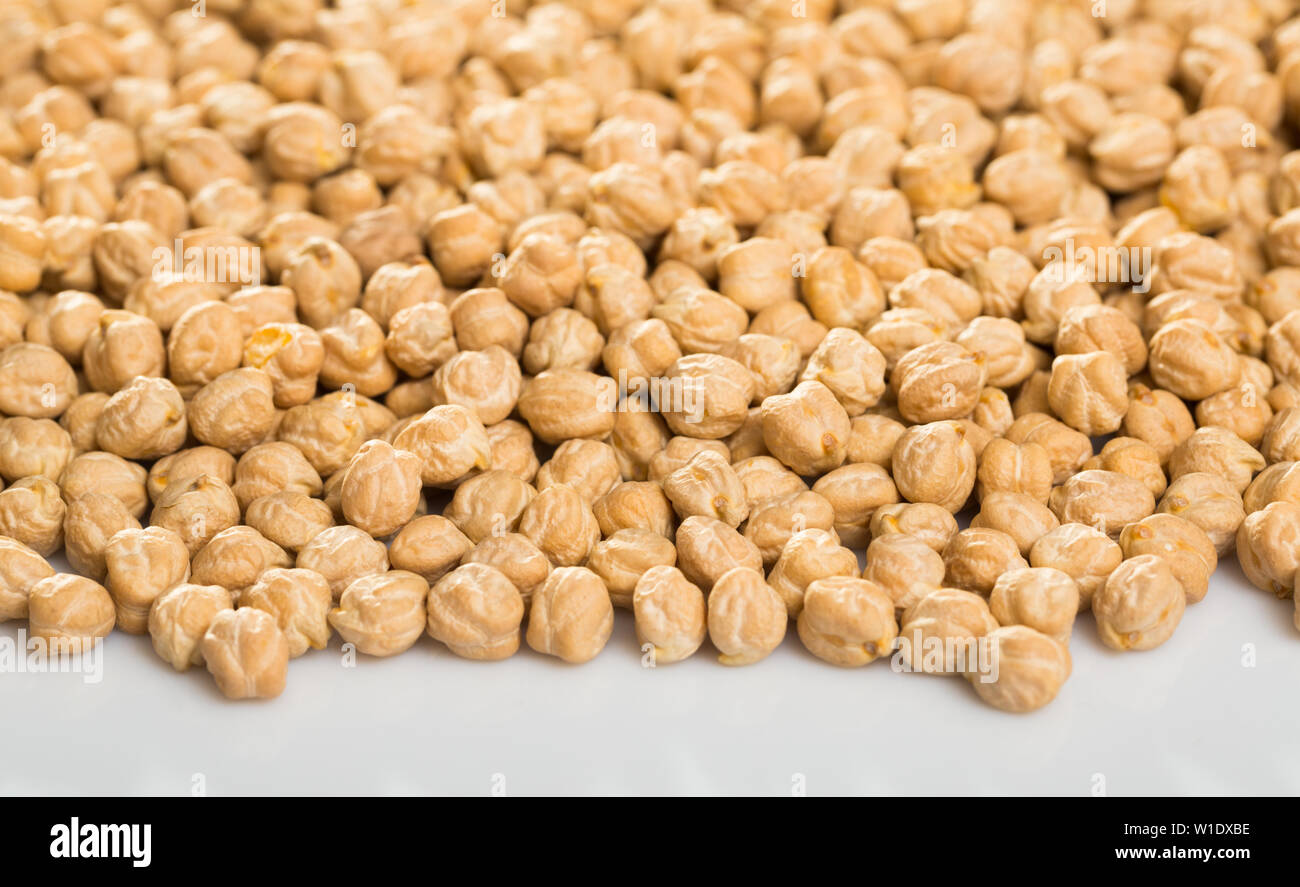 Natural background of dried chickpea seeds on white surface. Healthy ...