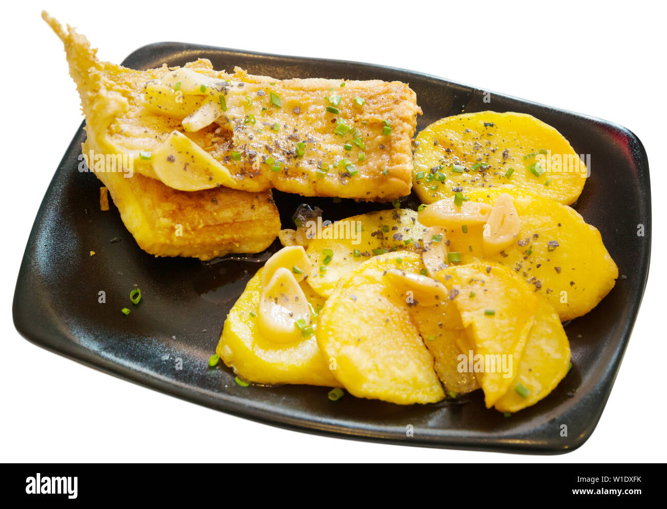 Delicious spicy breaded roasted ray wings served with potatoes. Typical ...