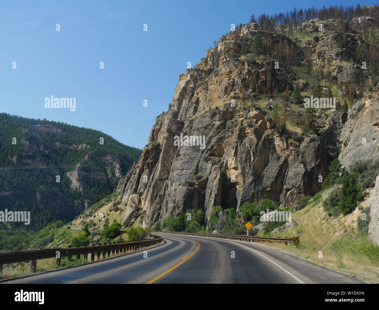 Incredible rock walls and geologic formations along a winding road ...