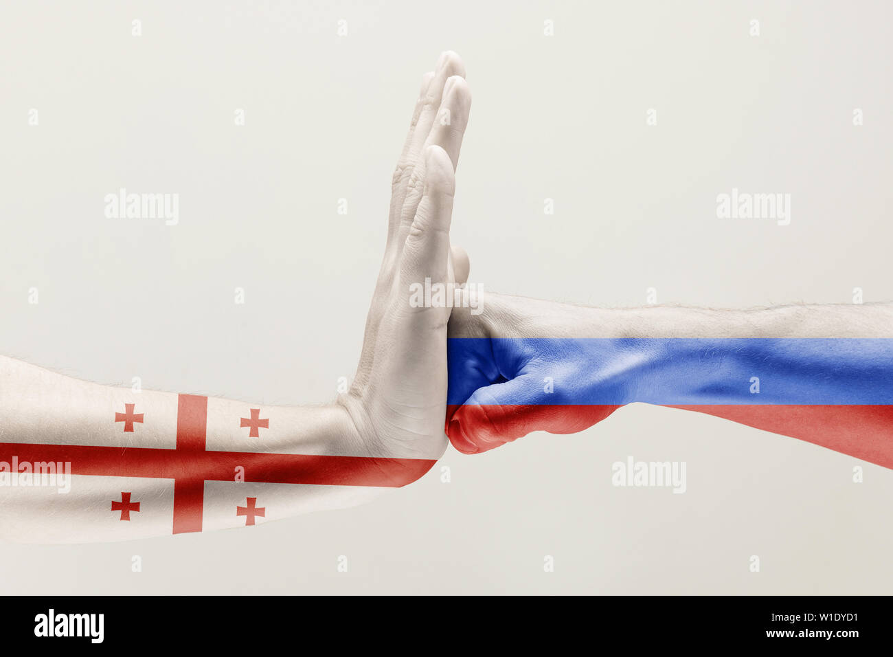 Stopping pressure. Two male hands fighting colored in Russian ...