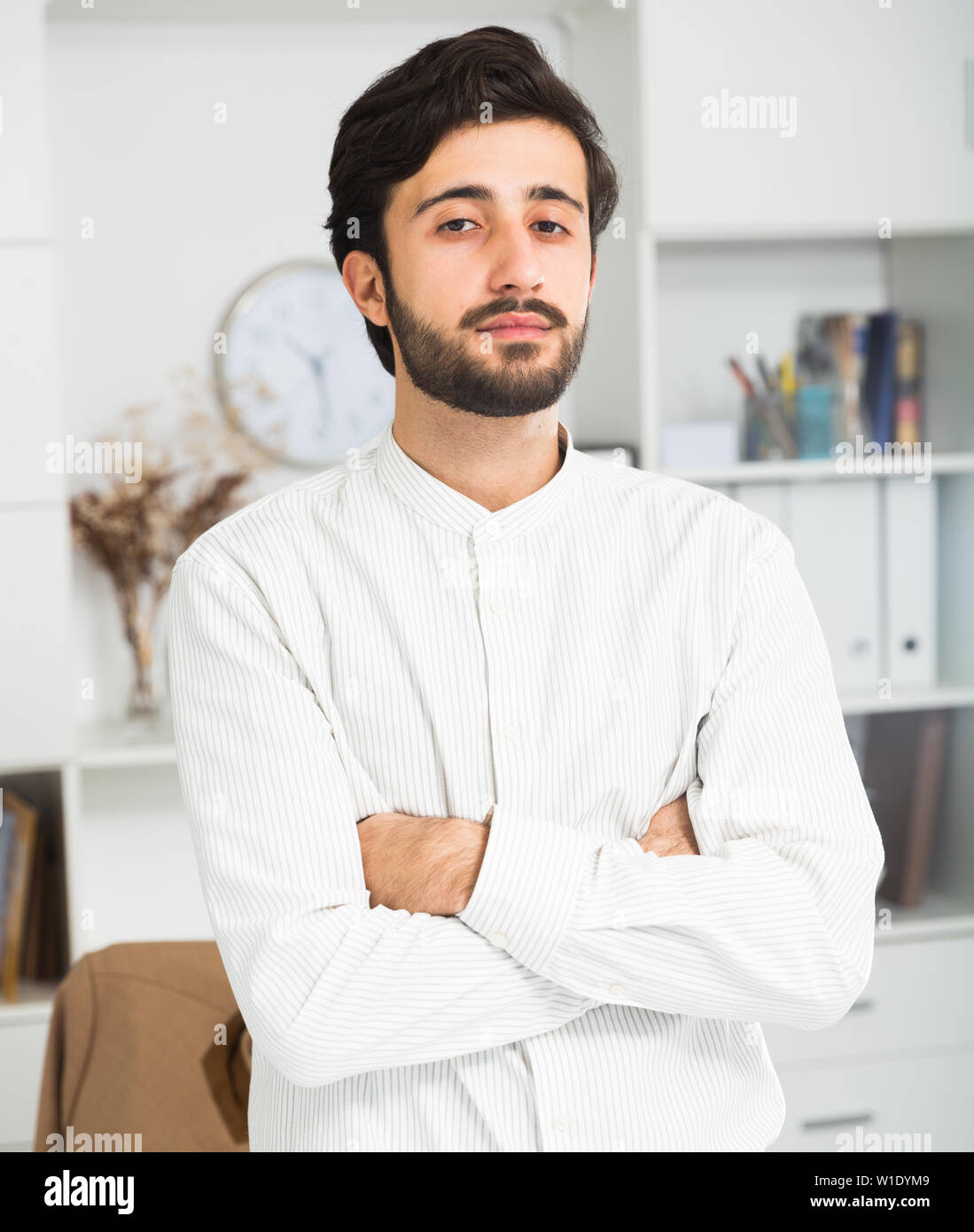 Portrait of handsome elegant office worker in office interior Stock ...