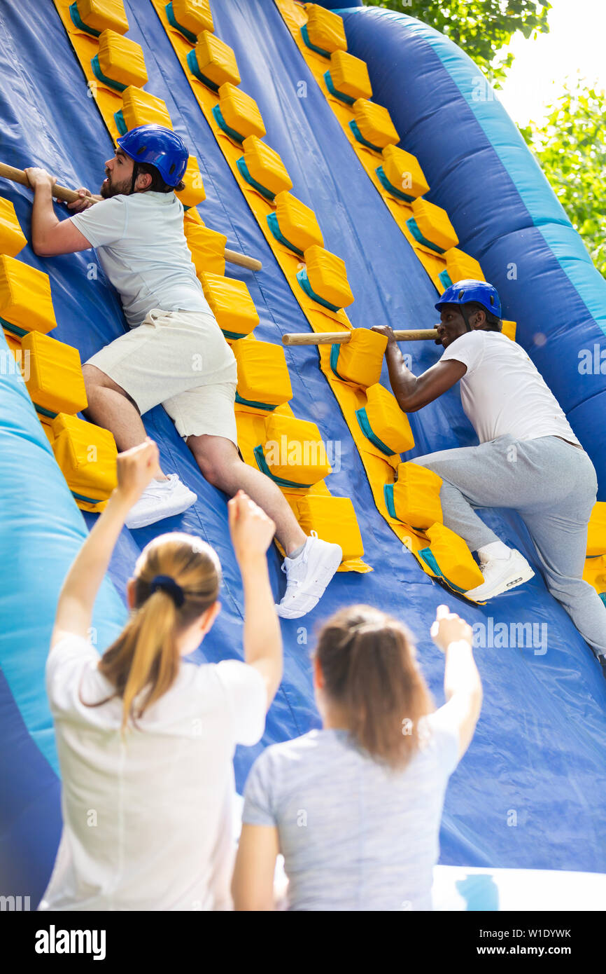 Inflatable slide Great race - climbing with a stick on an inflatable ...