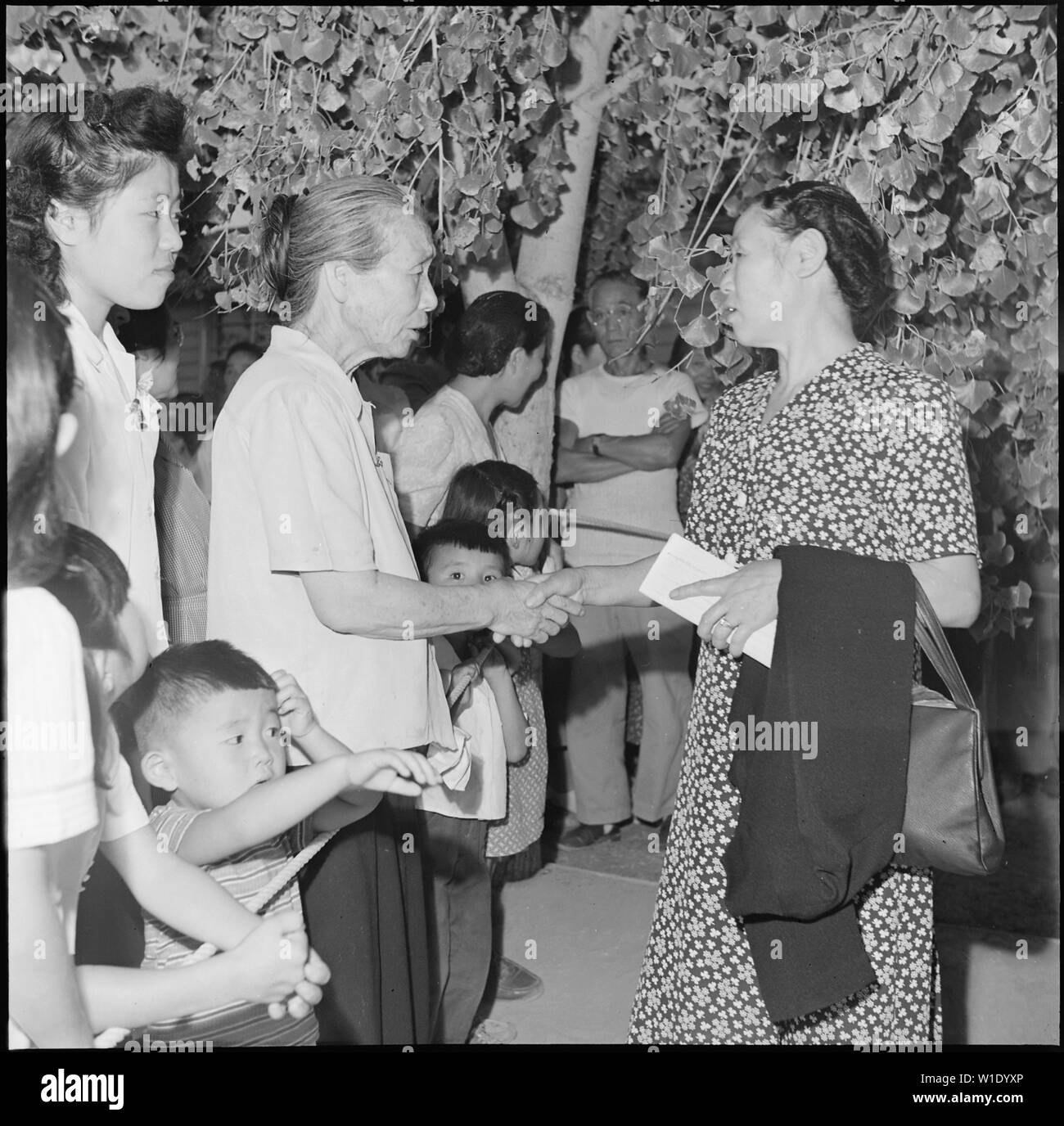 Gila River Relocation Center, Rivers, Arizona. Goodbyes are said as ...
