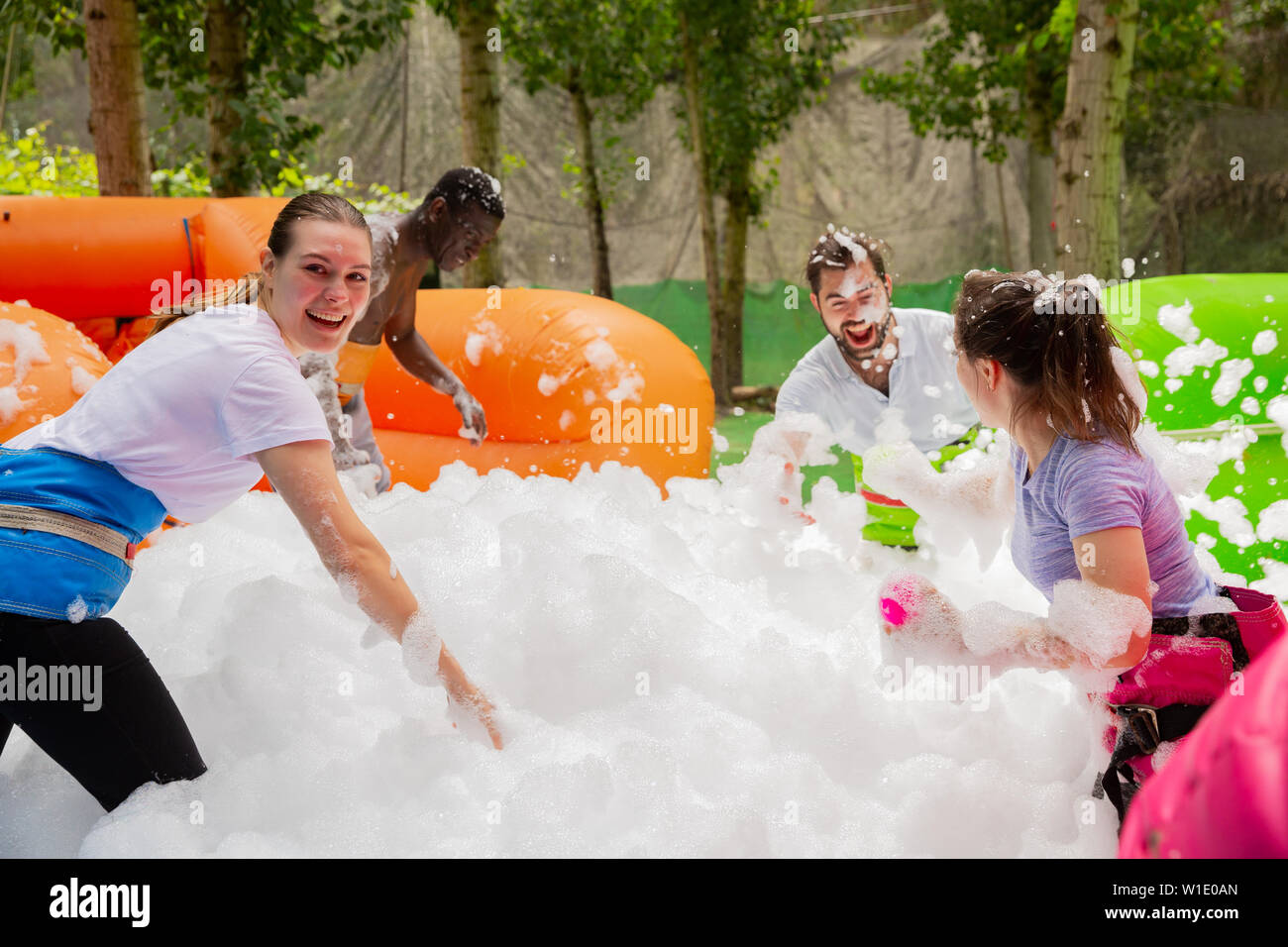 Friendly multiracial team having funny competition in collect of balls ...