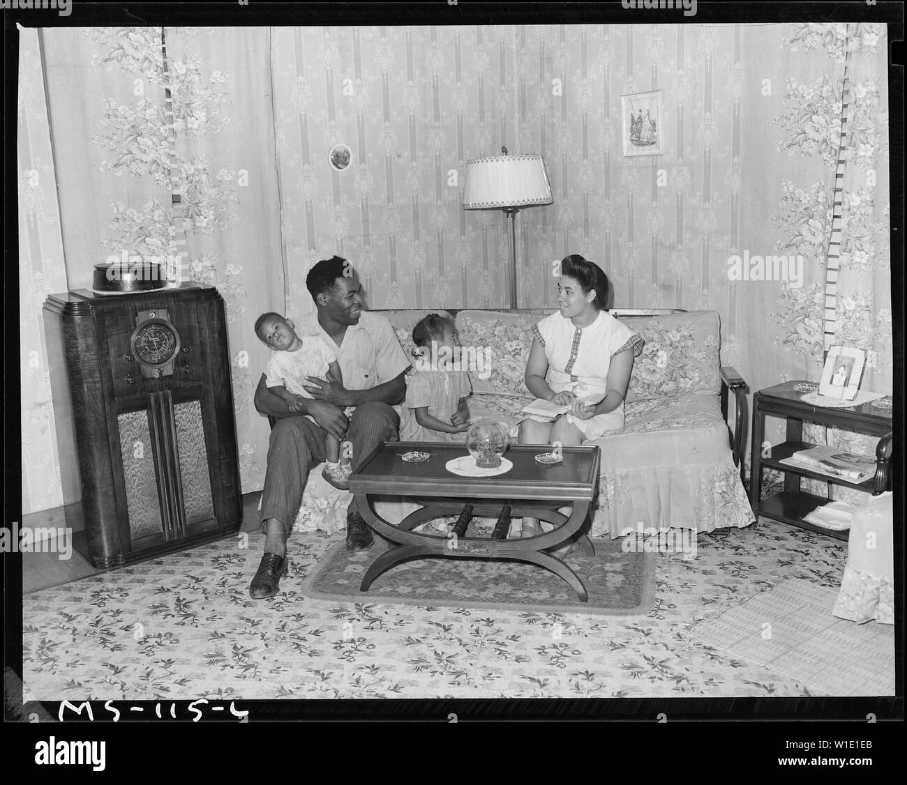Gonzalla Sullivan, miner, with his wife and children in living room of ...
