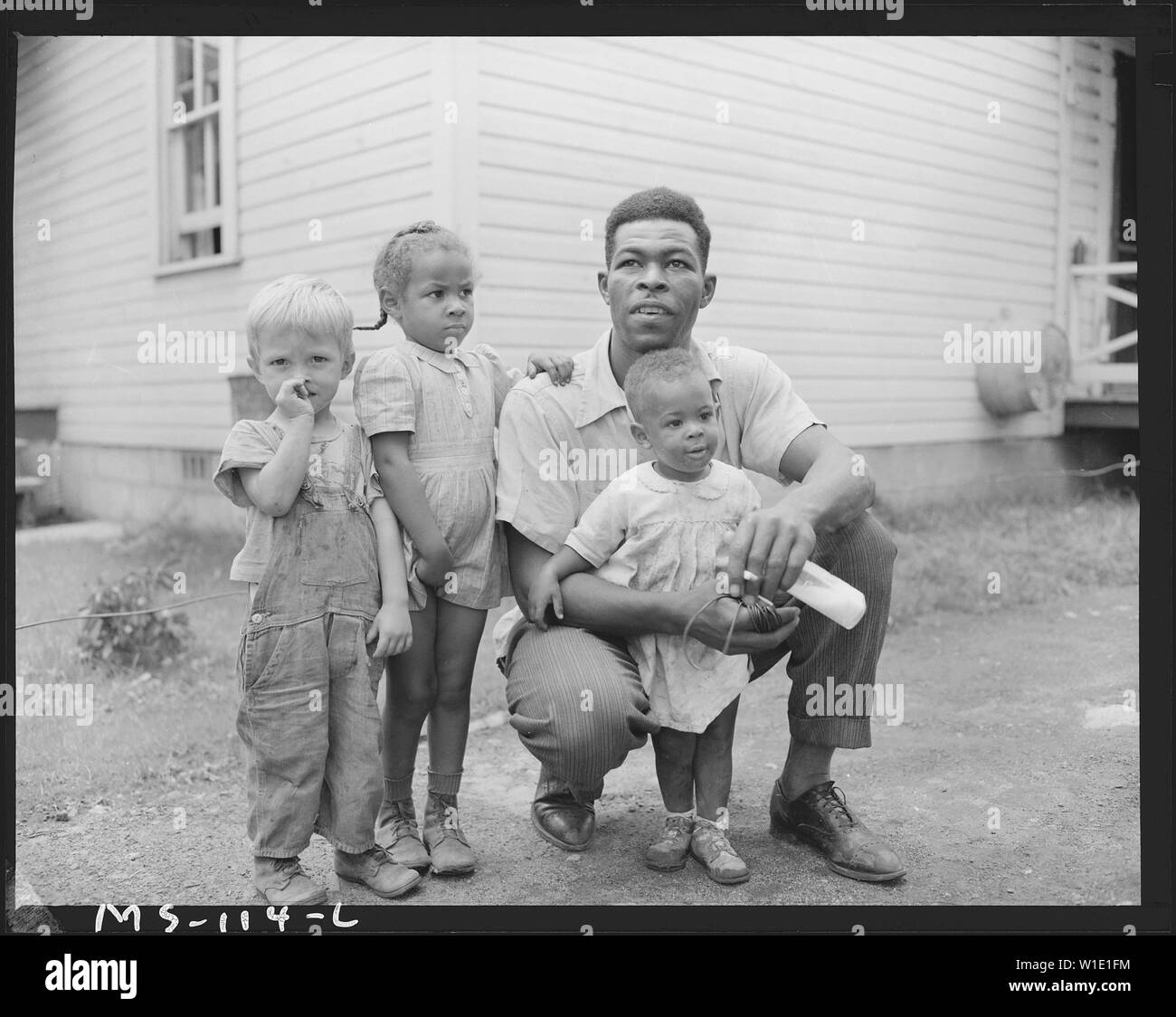 Gonzalla Sullivan, miner, with his two children and another child who ...