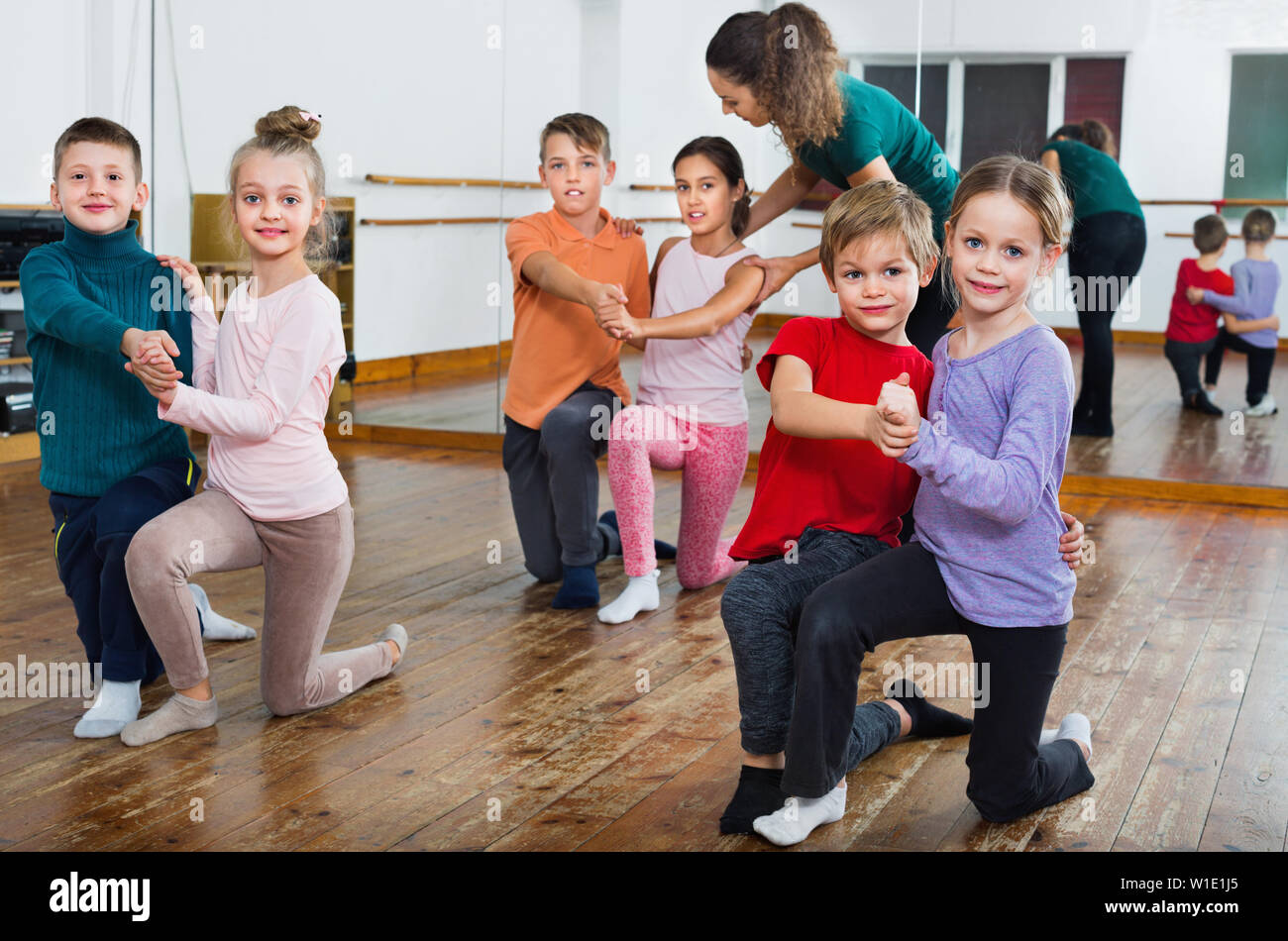 Positive children studying of partner dance at dance school Stock Photo ...
