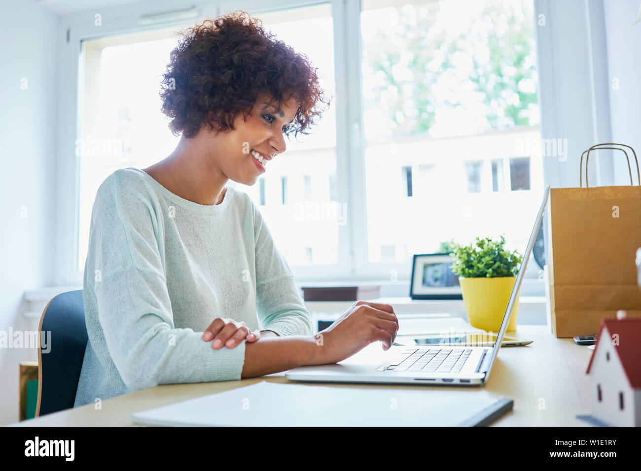 Happy woman working from home Stock Photo - Alamy