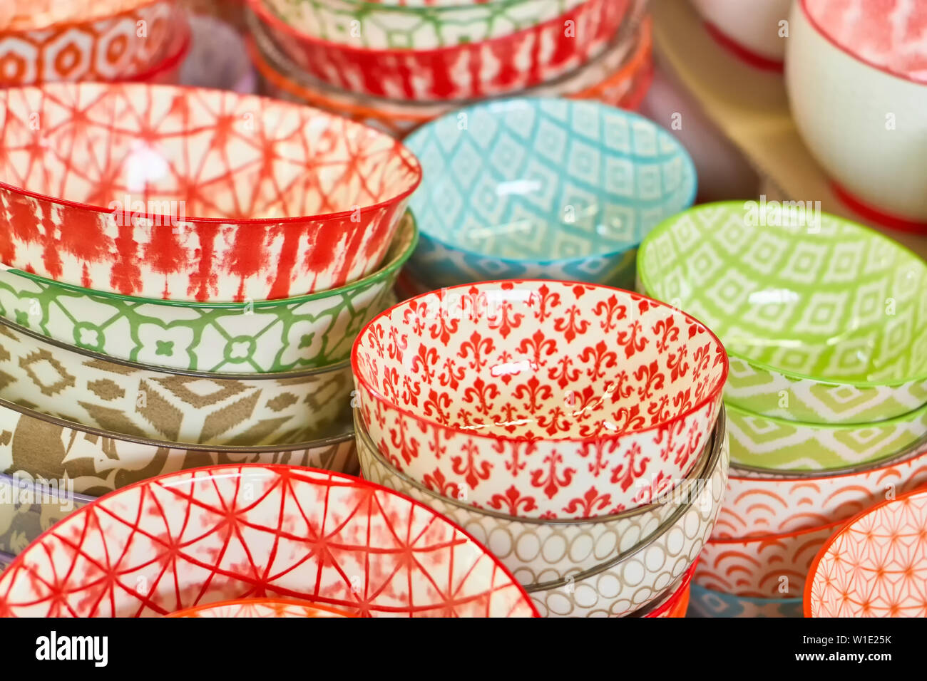 Group of ceramic bowls in the store. Dishes with different colorful ...