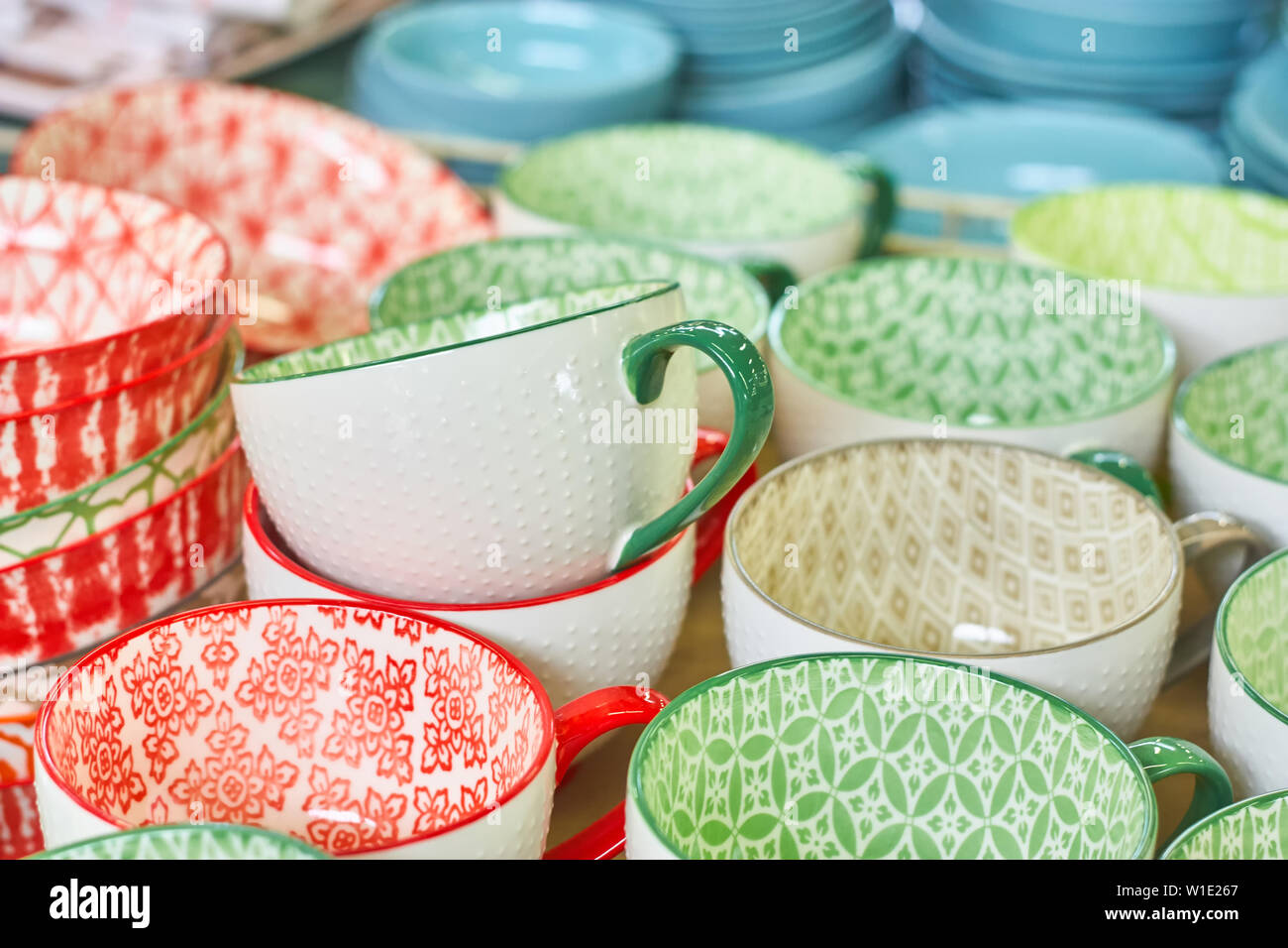 Group of ceramic bowls in the store. Dishes with different colorful ...