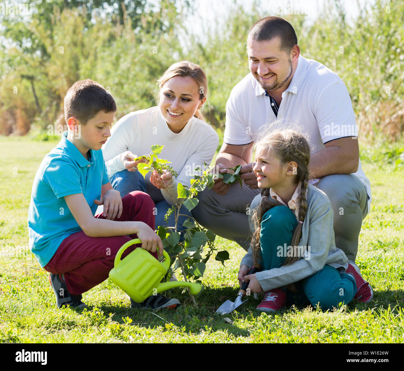 Children planting tree in park hi-res stock photography and images - Alamy