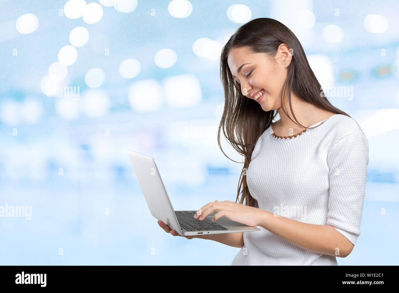 portrait of beautiful young woman holding laptop isolated Stock Photo ...