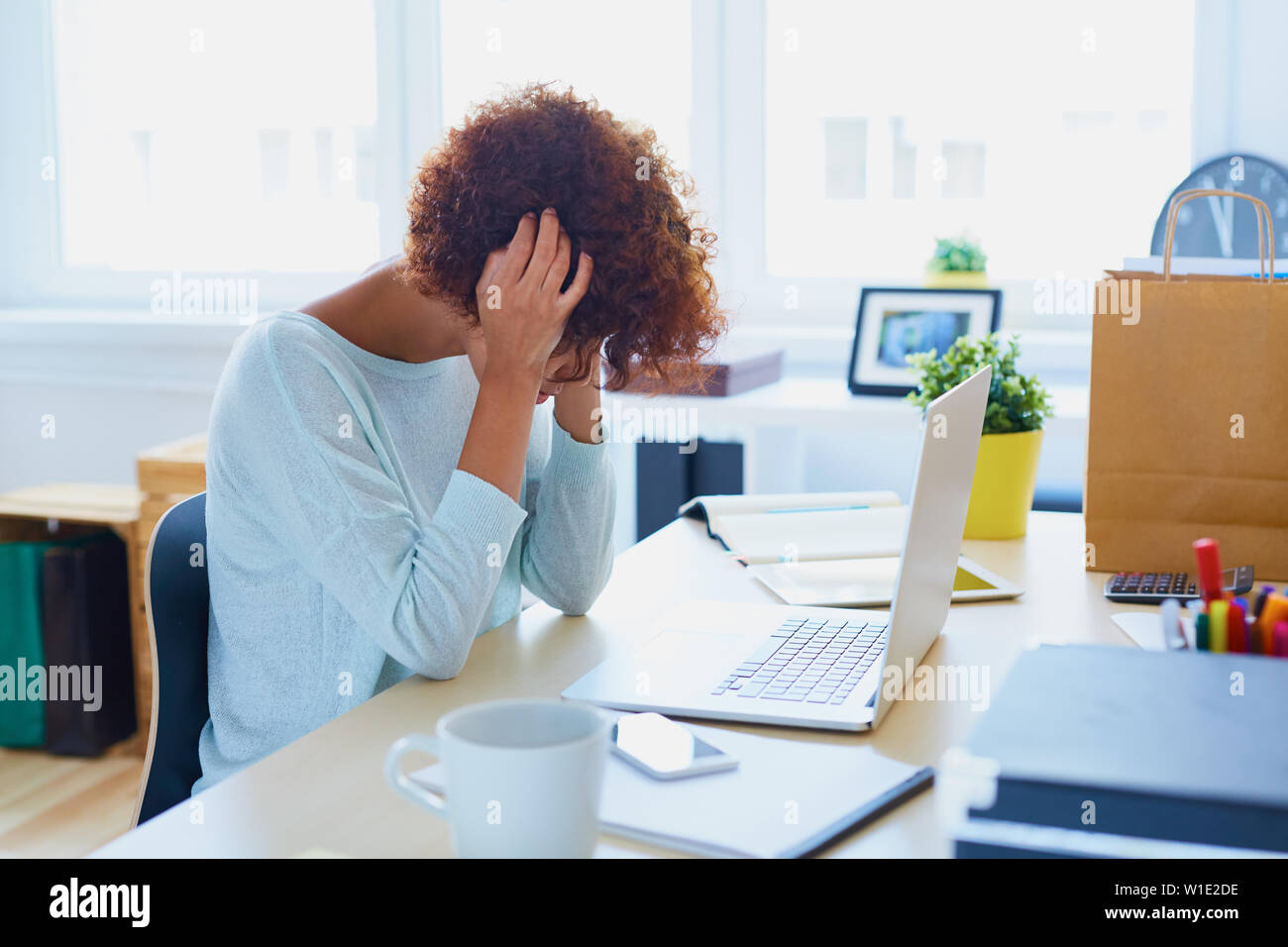 Dealing with failure - depressed african woman sitting in office ...