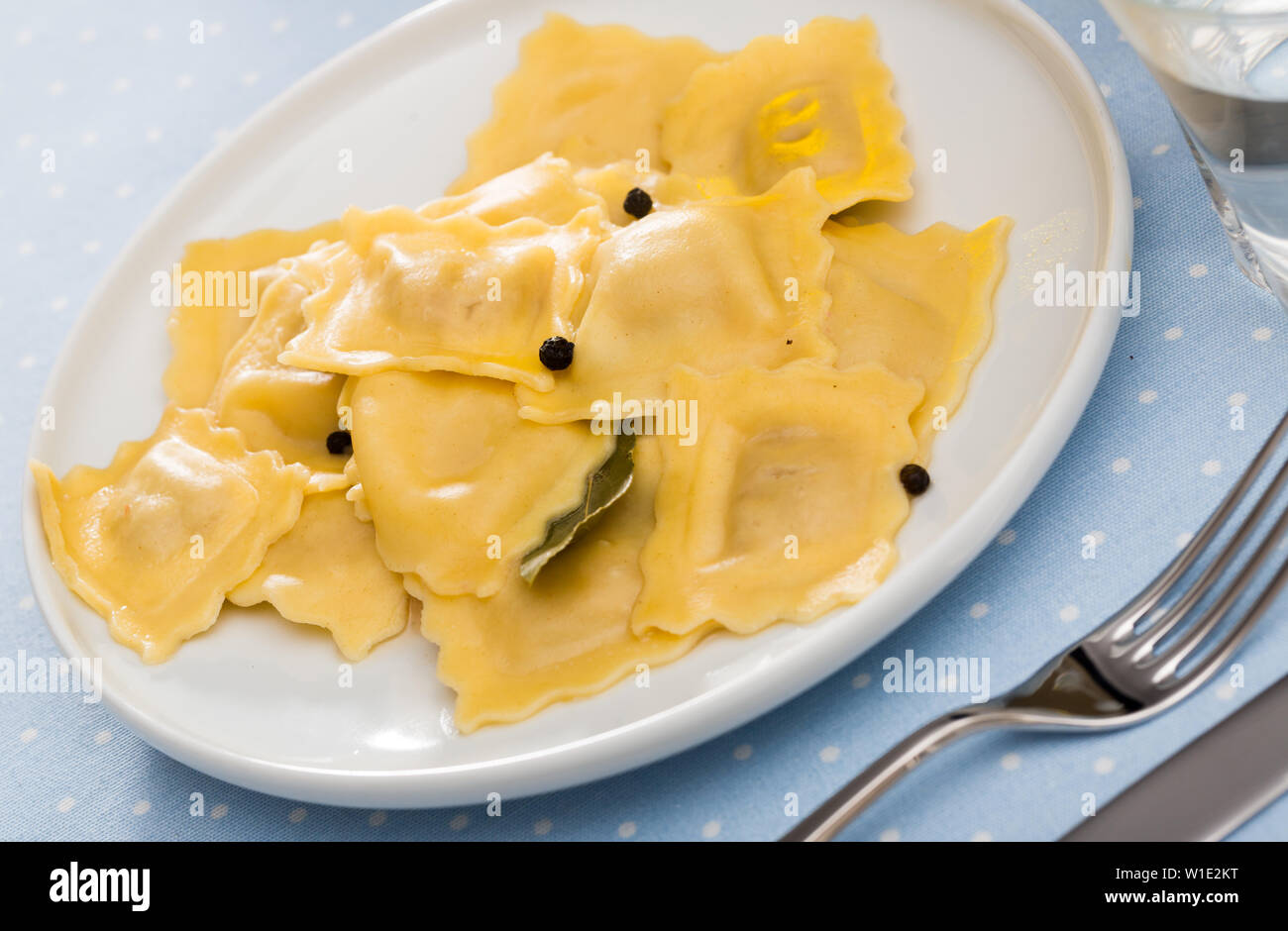 Traditional Italian ravioli served on white plate Stock Photo - Alamy