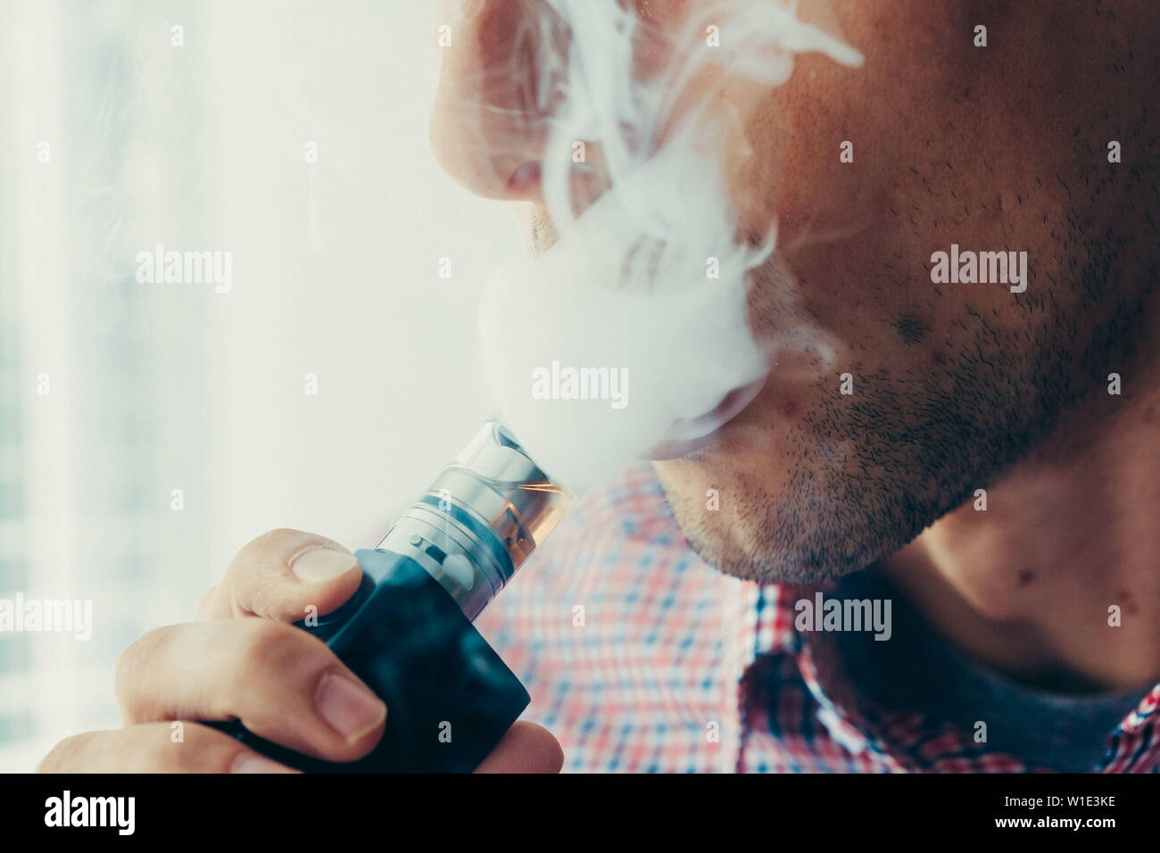 Man exhaling smoke from vaporizer hi-res stock photography and images ...