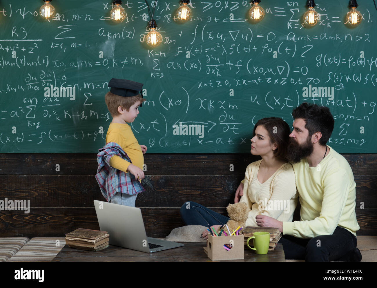 Learning at home. Little child learning at home with parents. Learning ...