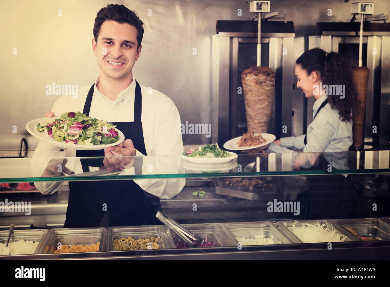 Restaurant staff posing at kebab counter and smiling Stock Photo - Alamy