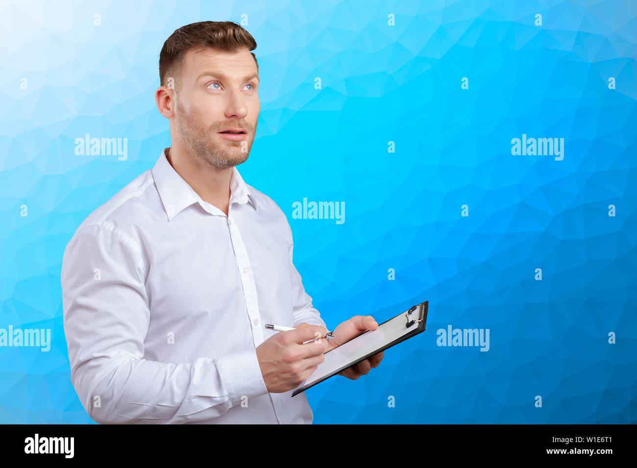 Portrait of young business man taking notes Stock Photo - Alamy