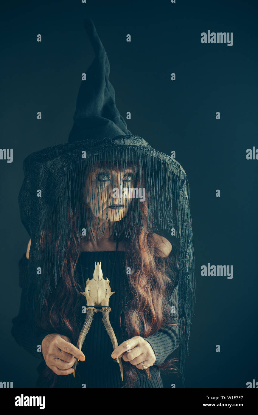 Halloween woman in black with long red hair and makeup. Halloween old ...