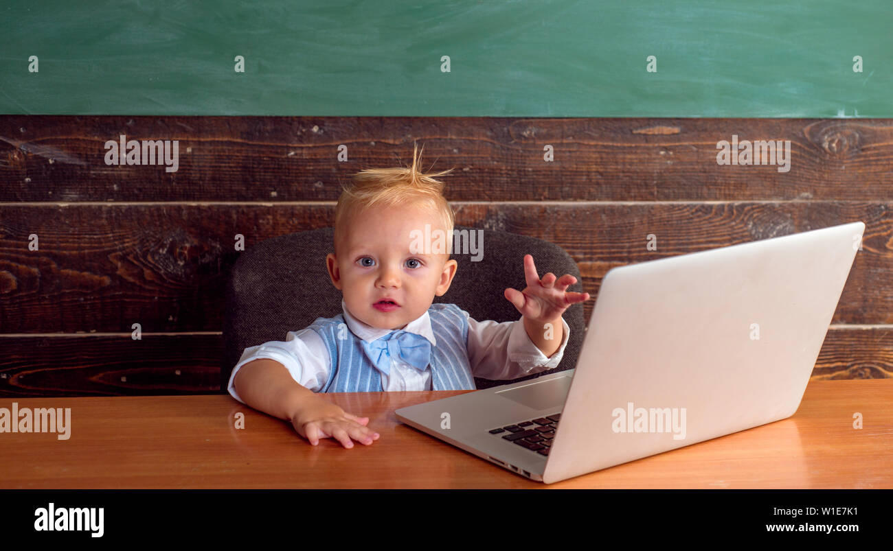 Little boy learning computer language in classroom. Online learning in ...