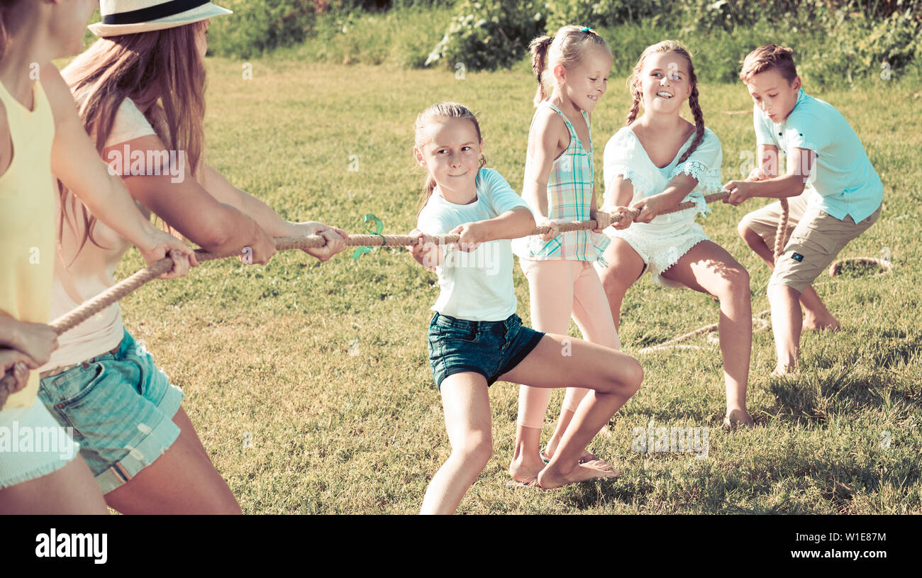 Group of laughing people with little kids having fun together outdoors ...