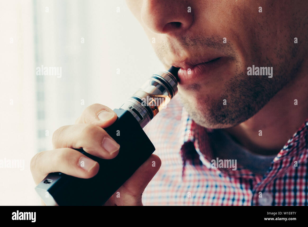 Close up on a man exhaling vapor from an electronic cigarette Stock ...